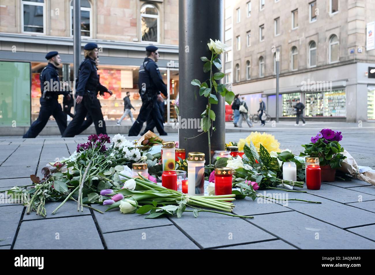 Mannheim, Germany. 04th Mar, 2025. Candles and flowers lie near the ...
