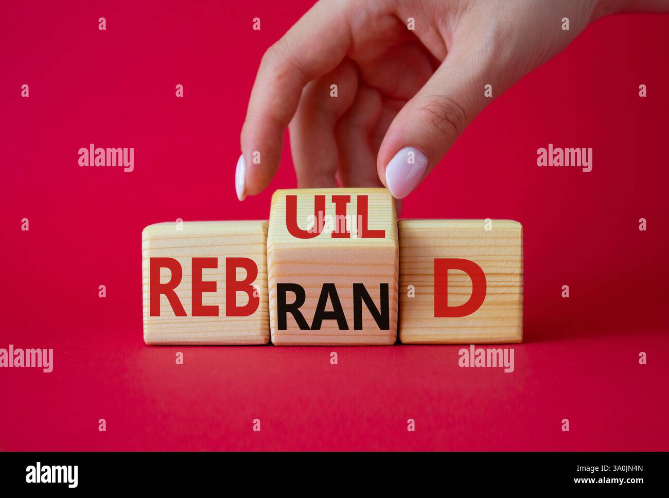 Rebuild and Rebrand symbol. Businessman hand turns wooden cubes and ...