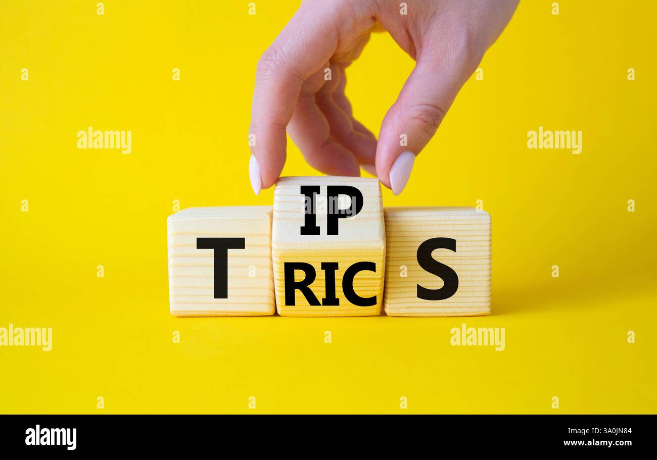 Tips and Tricks symbol. Businessman Hand turns cubes and changes word ...
