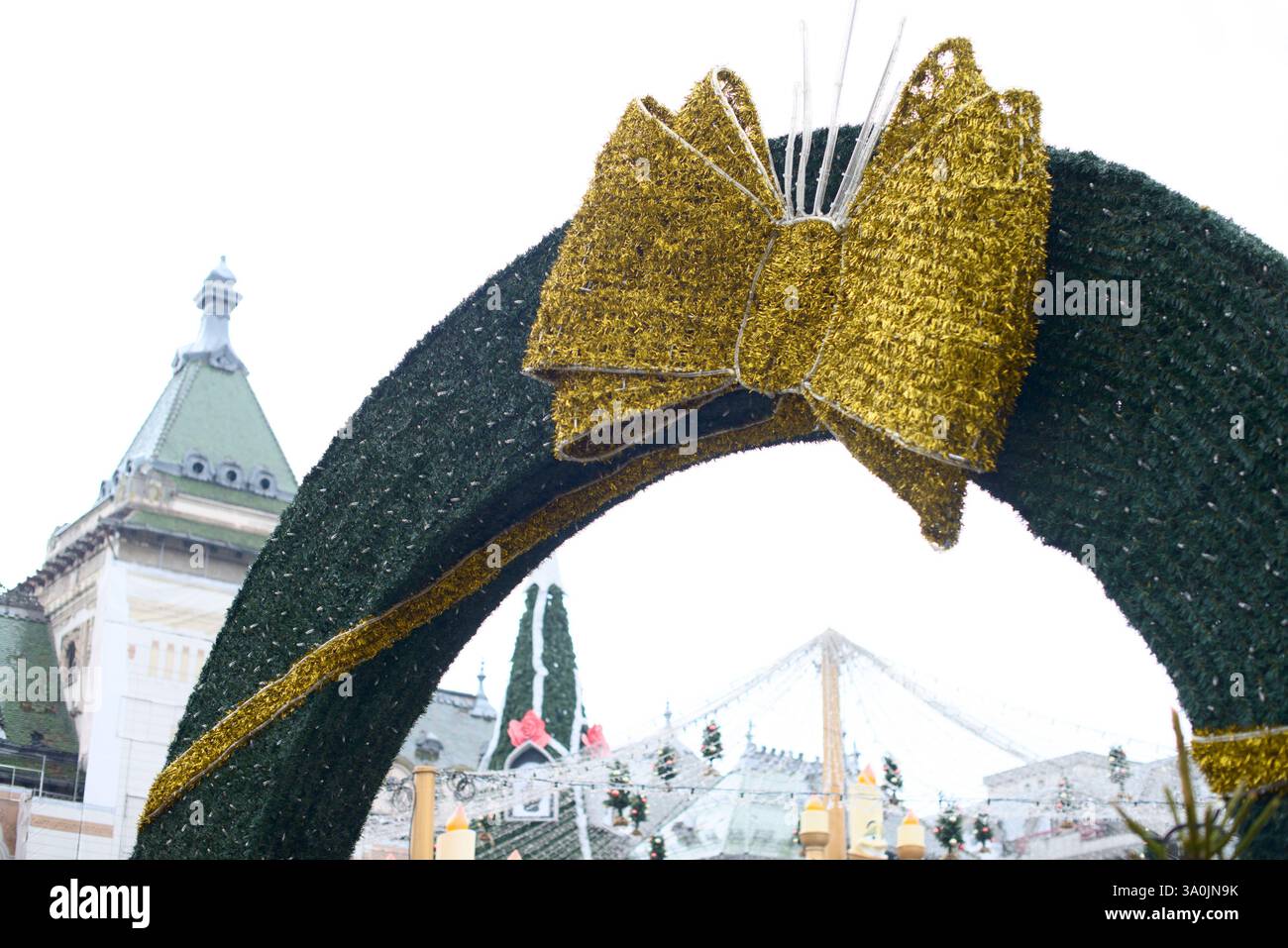 A tall arch with a glittering golden bow stands at Craiovas Christmas ...
