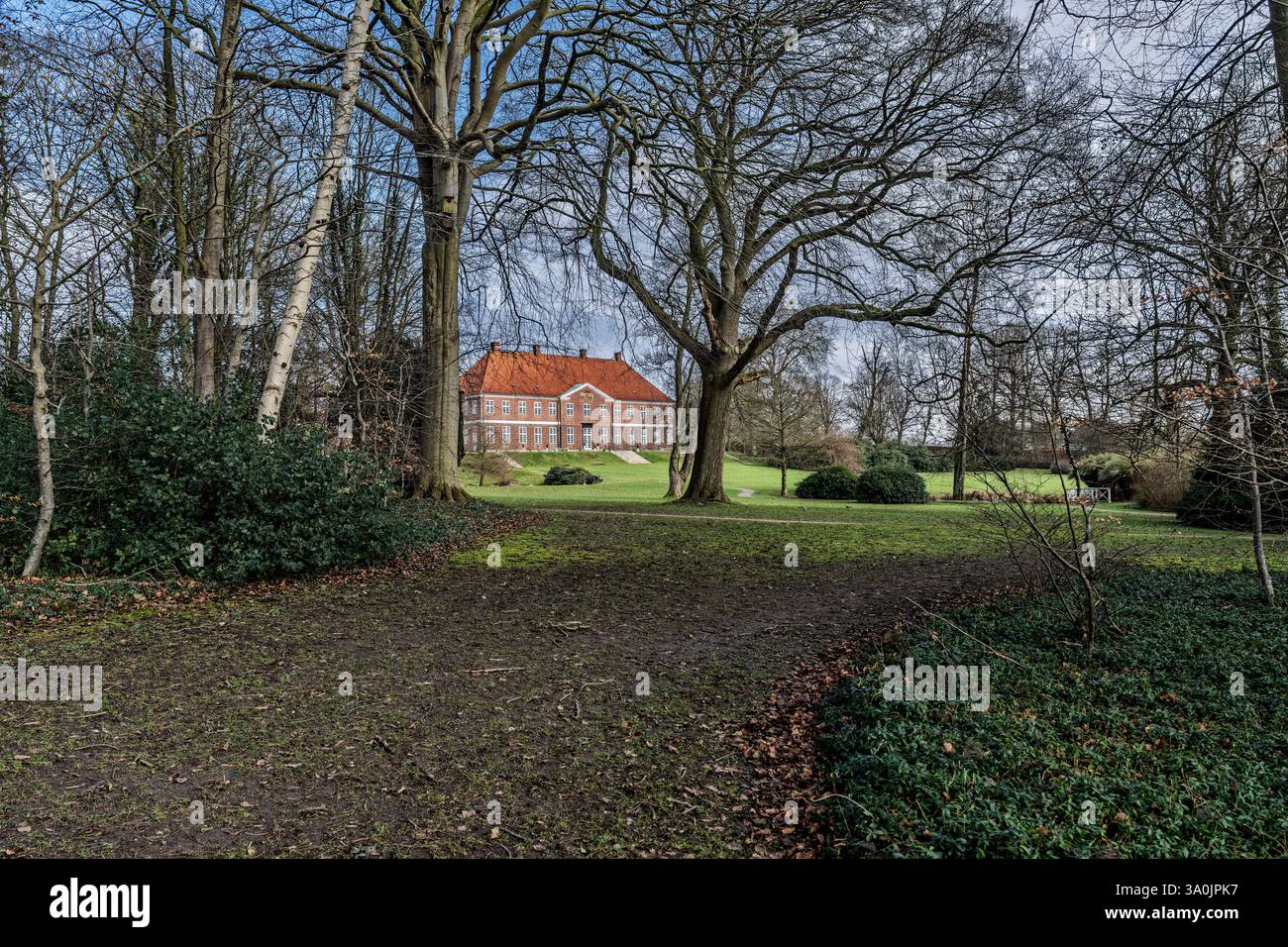 A historical mansion with a red tiled roof is nestled amidst a serene ...