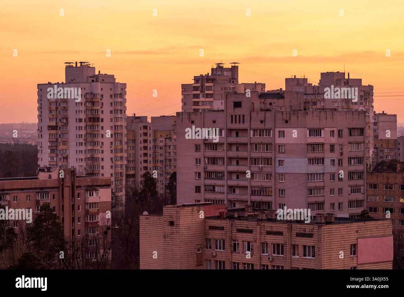 Beautiful sunset behind high-rise buildings of Kyiv Stock Photo - Alamy