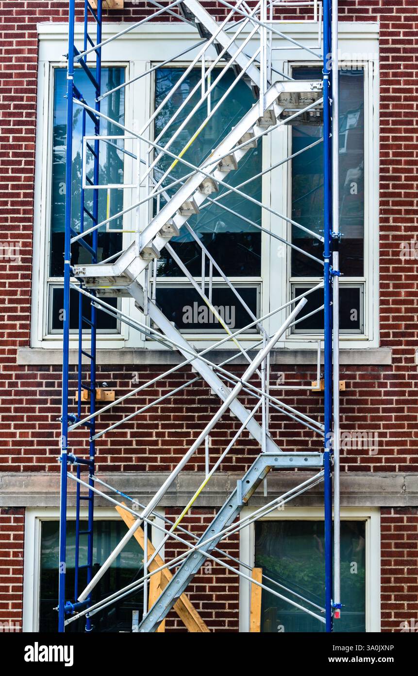 daytime summer front view of scaffolding on the face of a rmulti storey ...