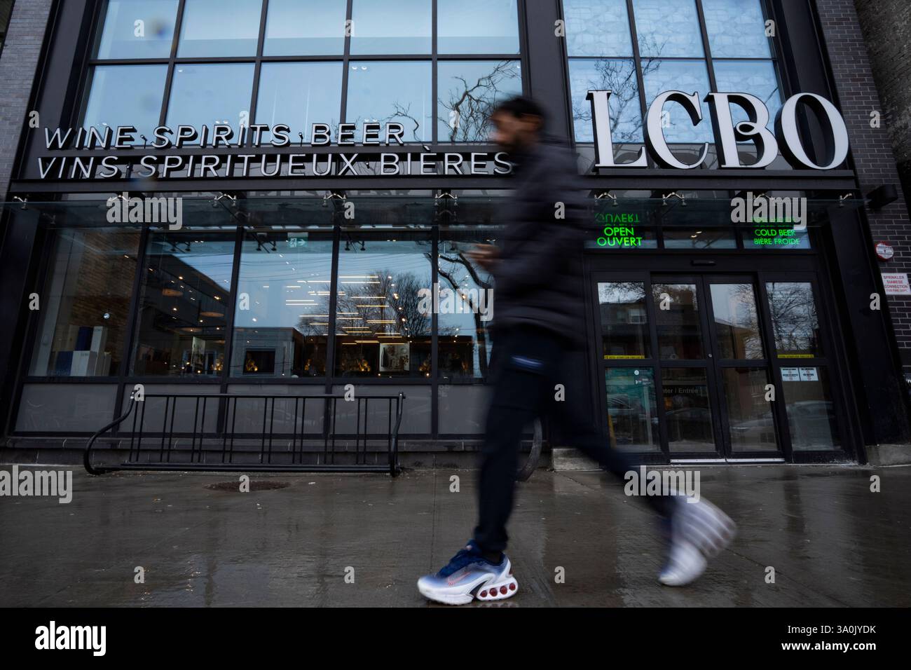 Toronto, Canada. 04th Mar, 2025. A persons walks by an LCBO in Toronto ...