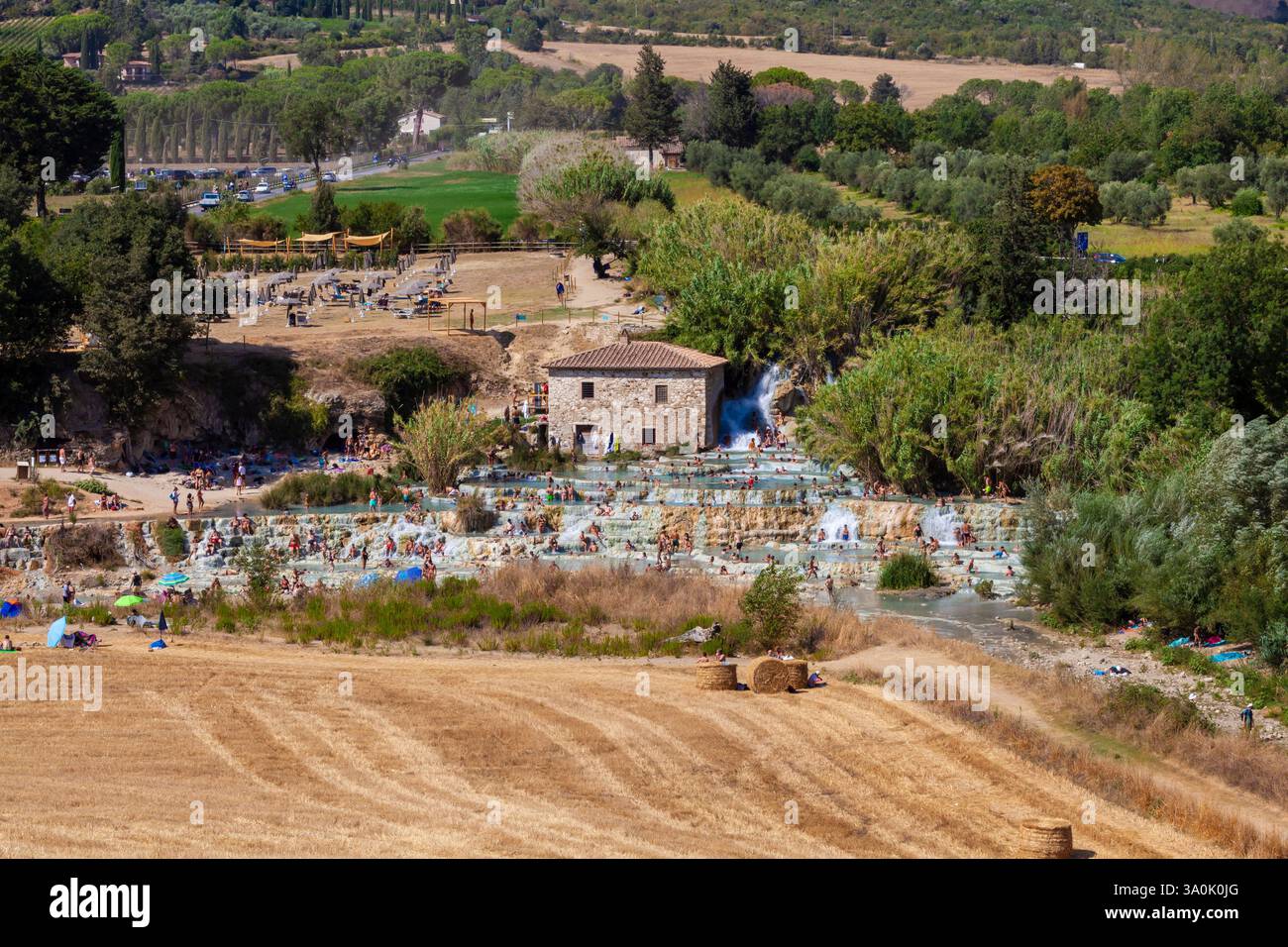 Free thermal baths in Saturnia with vibrant blue waters, cascading ...