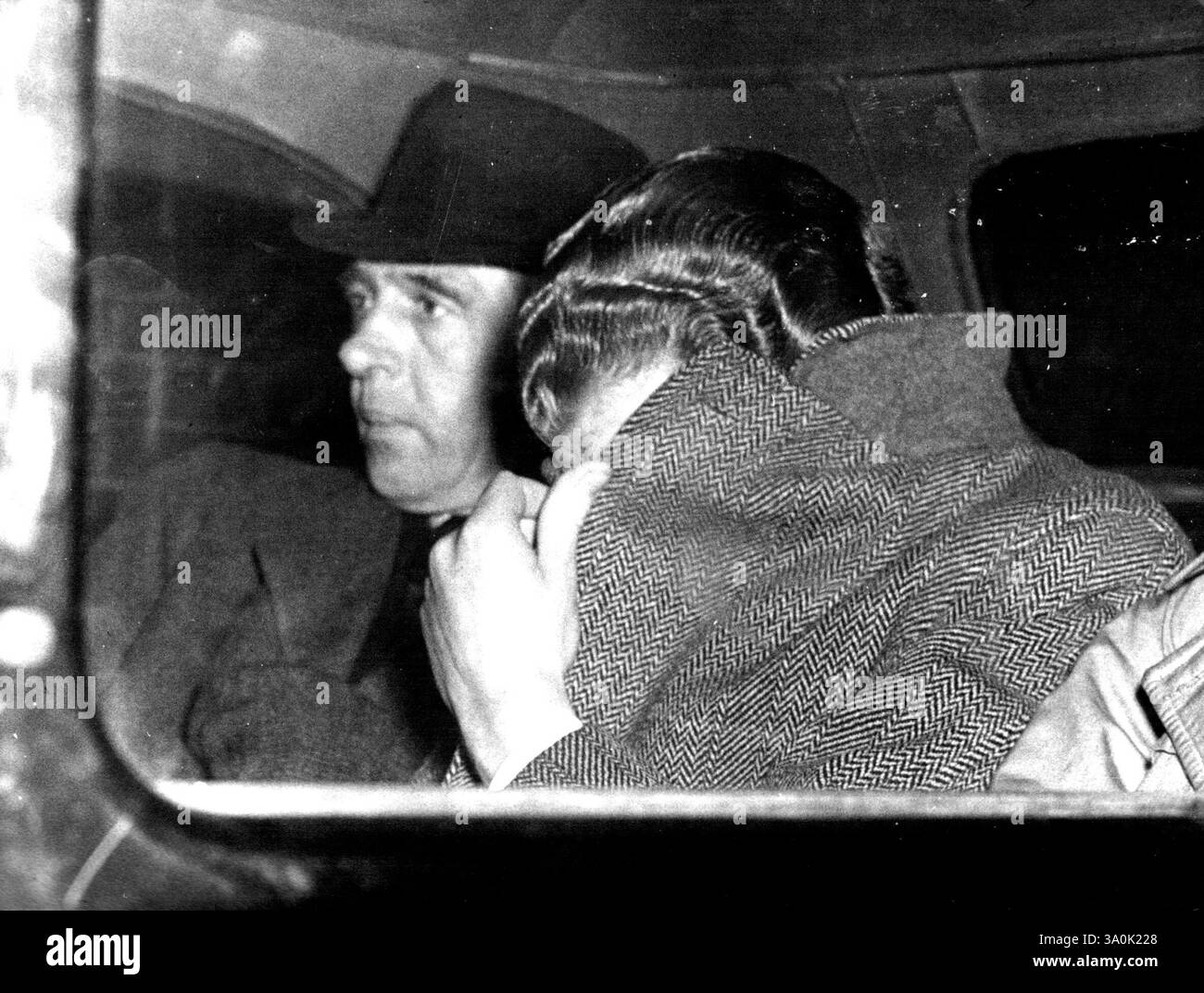 Derek William Bentley covering his face with the lap of his overcoat as ...