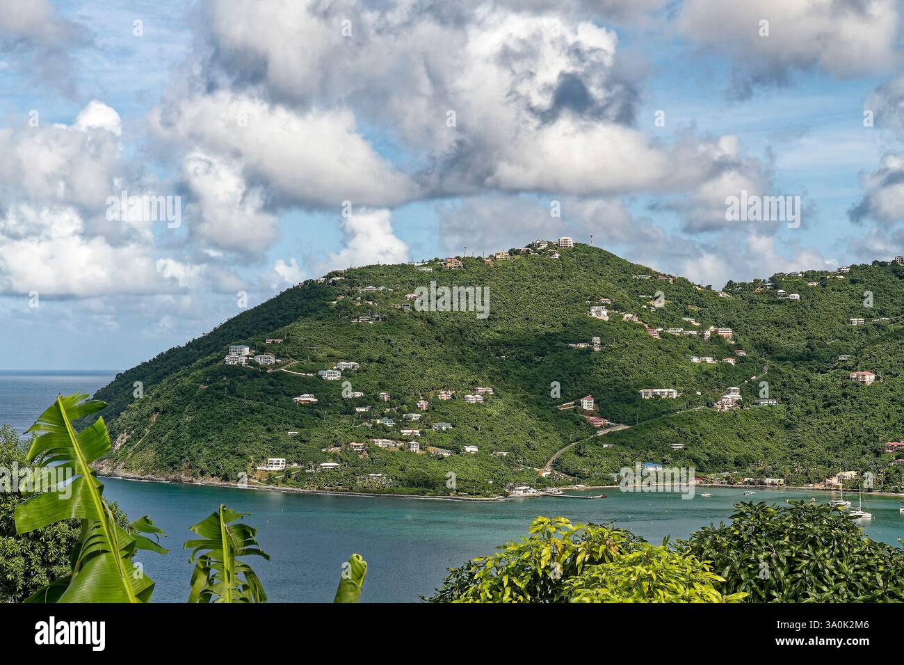 island overview, hillside, green vegetation, buildings, blue water ...