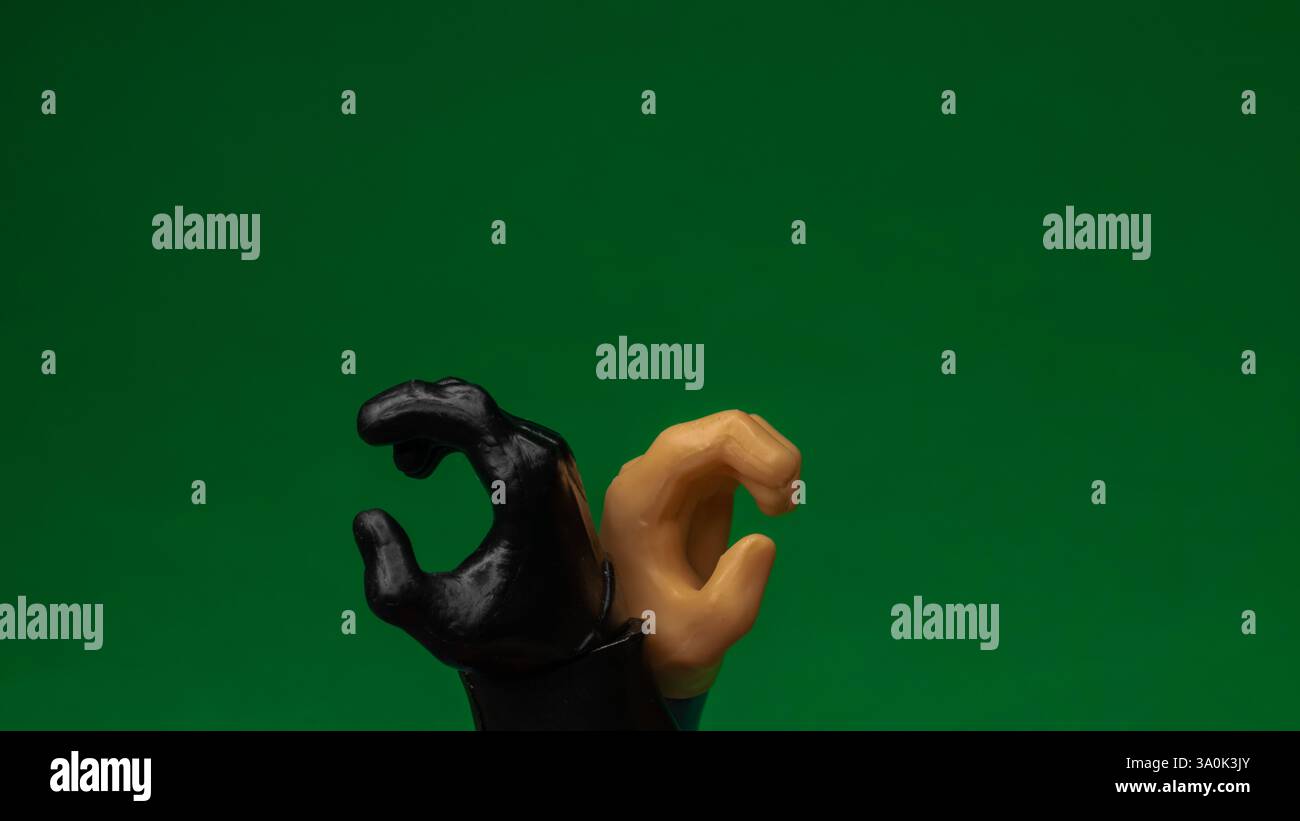 Human and robot hand doing sign language isolated on green background ...