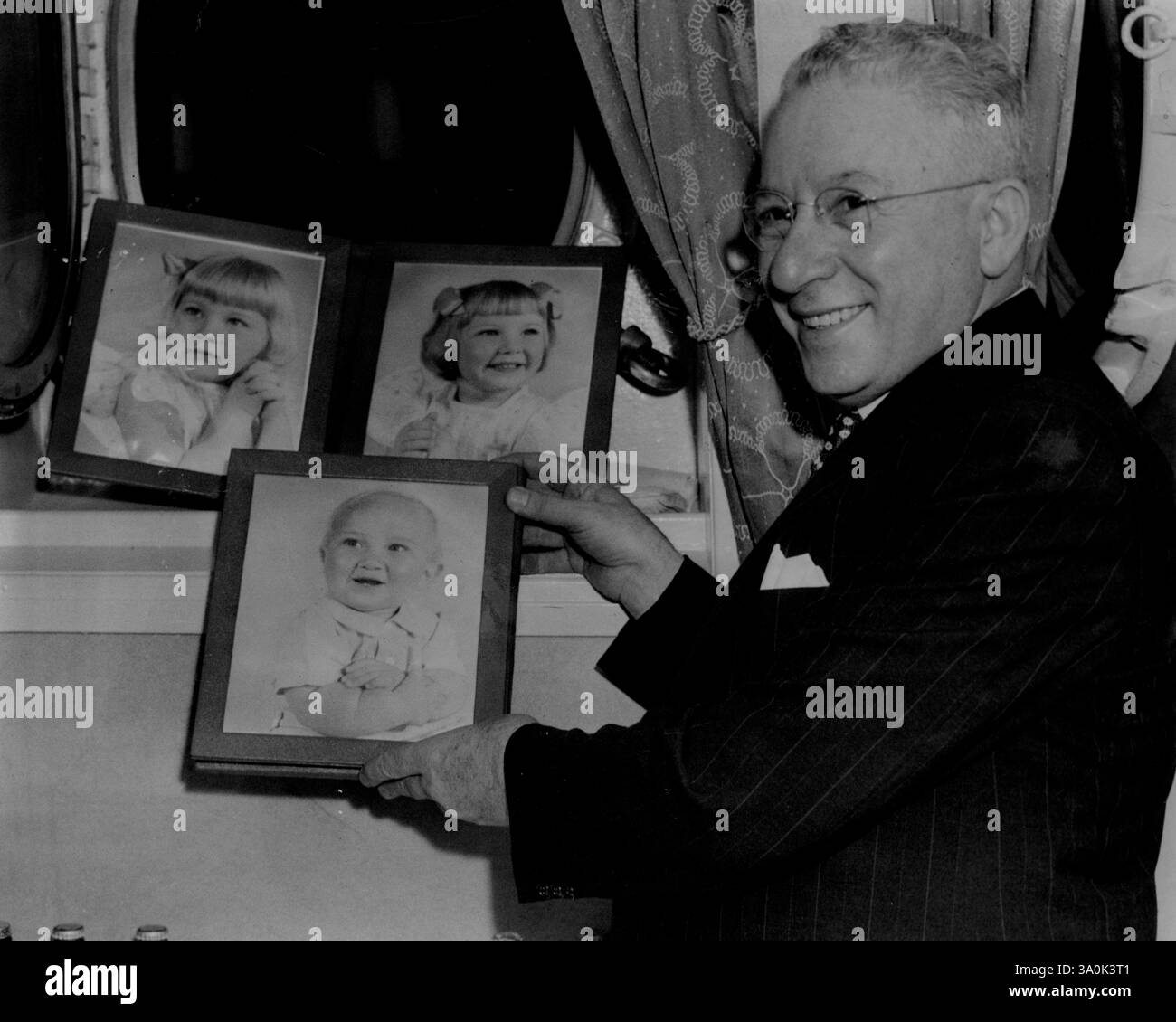 Sydney jeweller and race-horse owner Adolph Basser with photographs of ...