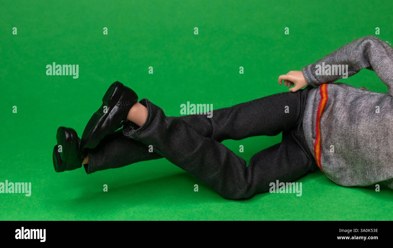 Doll toy laying sideways with visible legs Stock Photo - Alamy