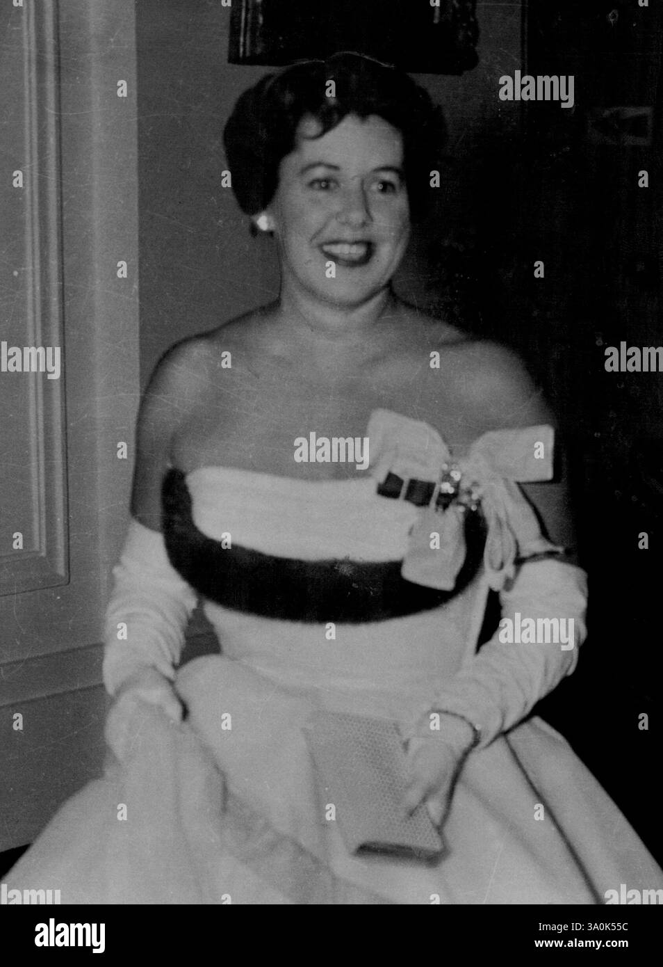 Lovely evening gown of sea-blue chiffon to her own design, with a mink ...