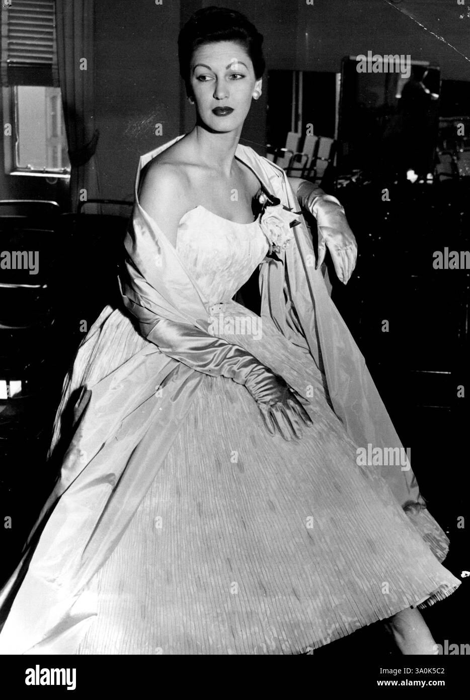 Ballerina gown of pleated organdie, white patterned in yellow is worn ...