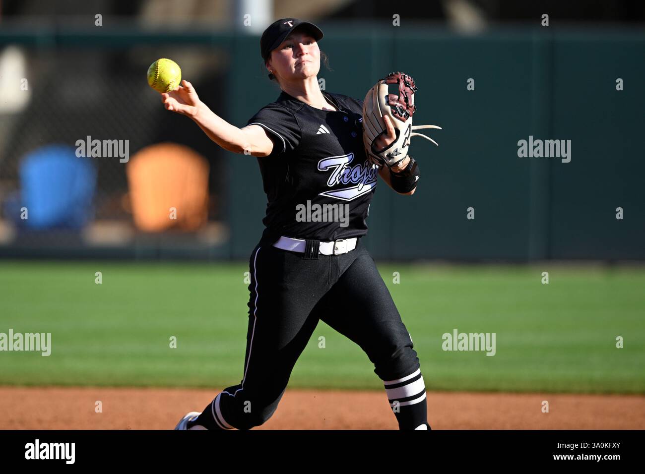 Troy infielder Reese Green (20) throws during an NCAA college softball ...