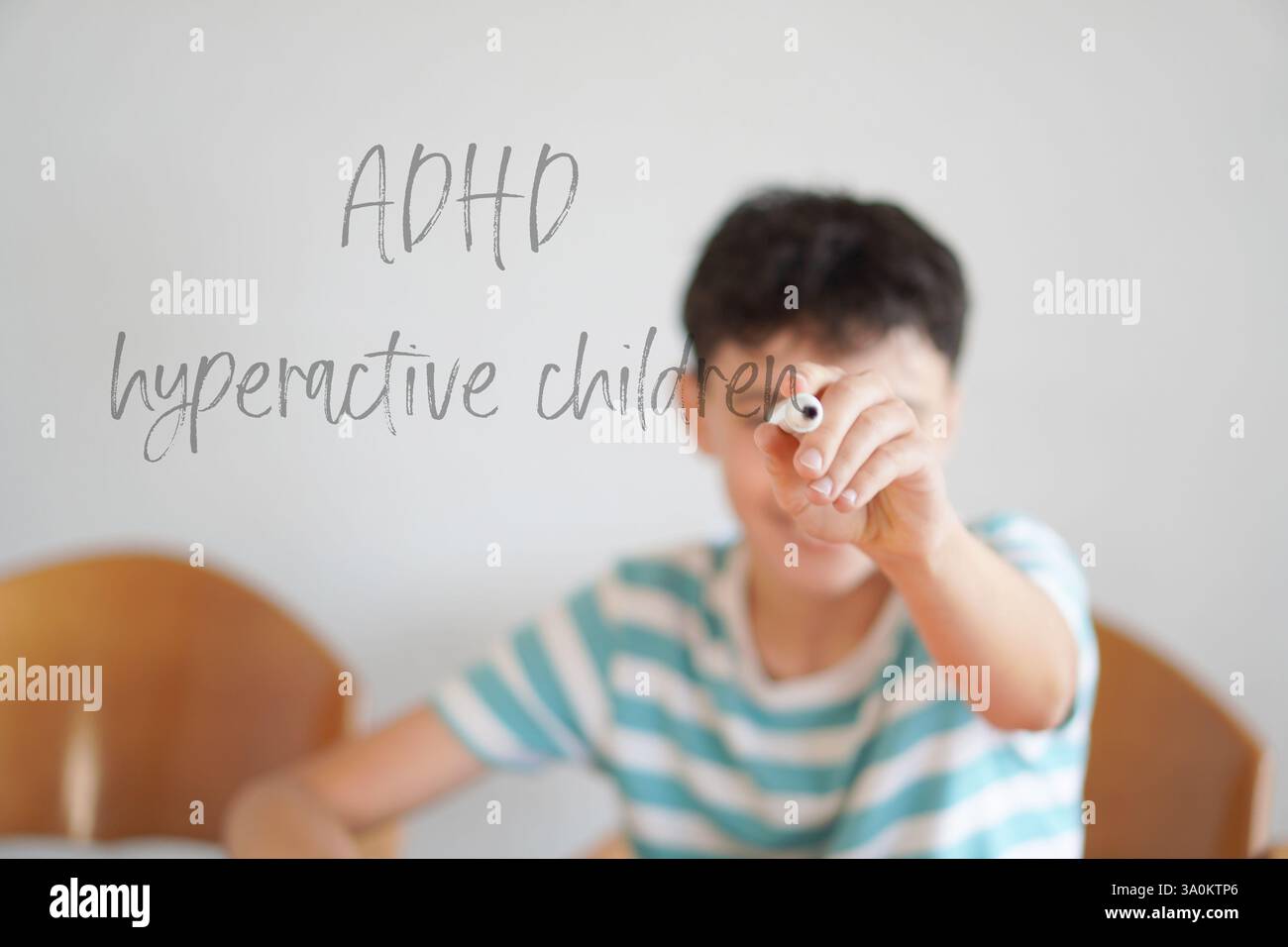 adhd concept. hyperactive children. preteen boy writing the word with a ...
