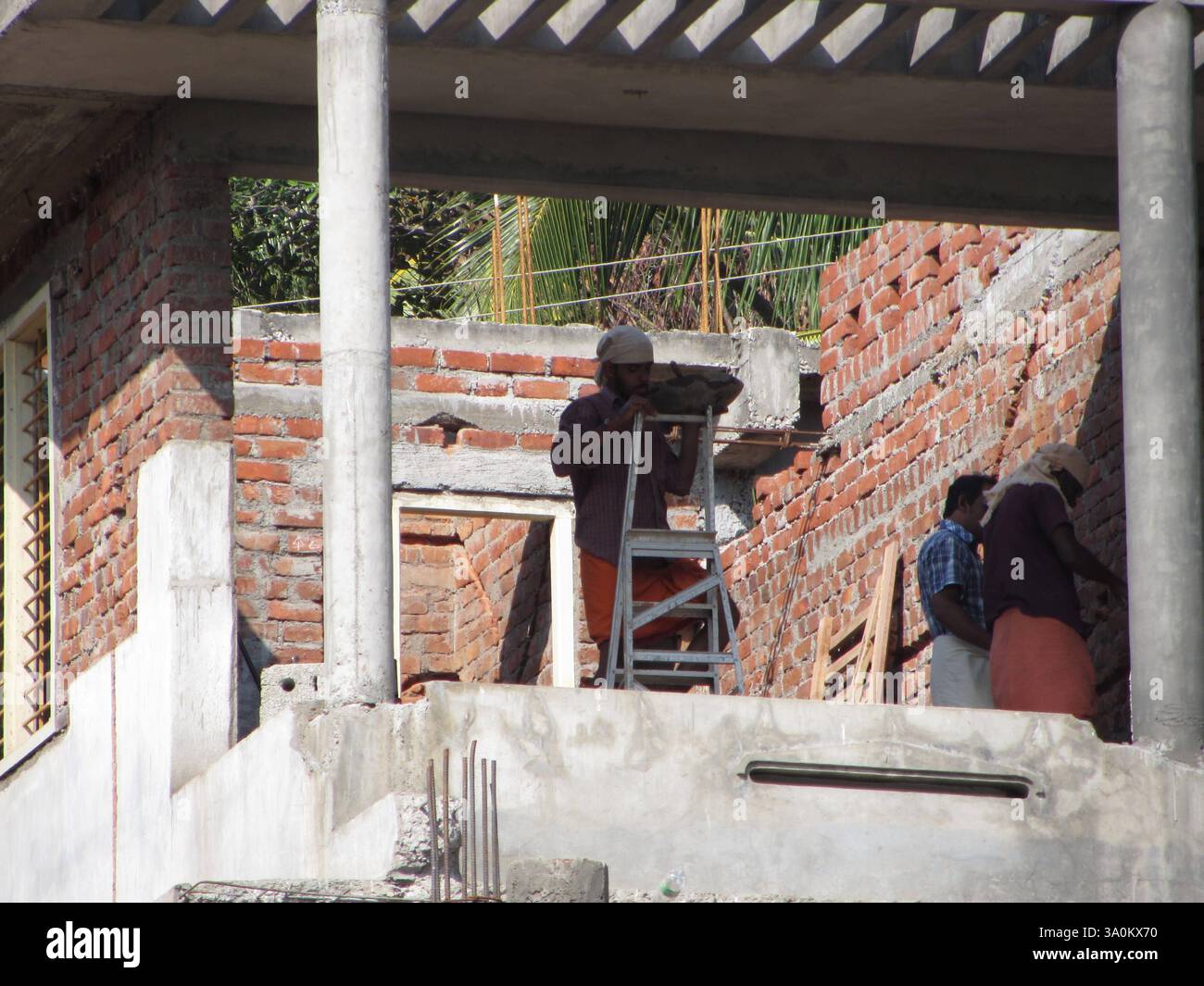 mason builds a brick wall, building work on a construction site mason ...