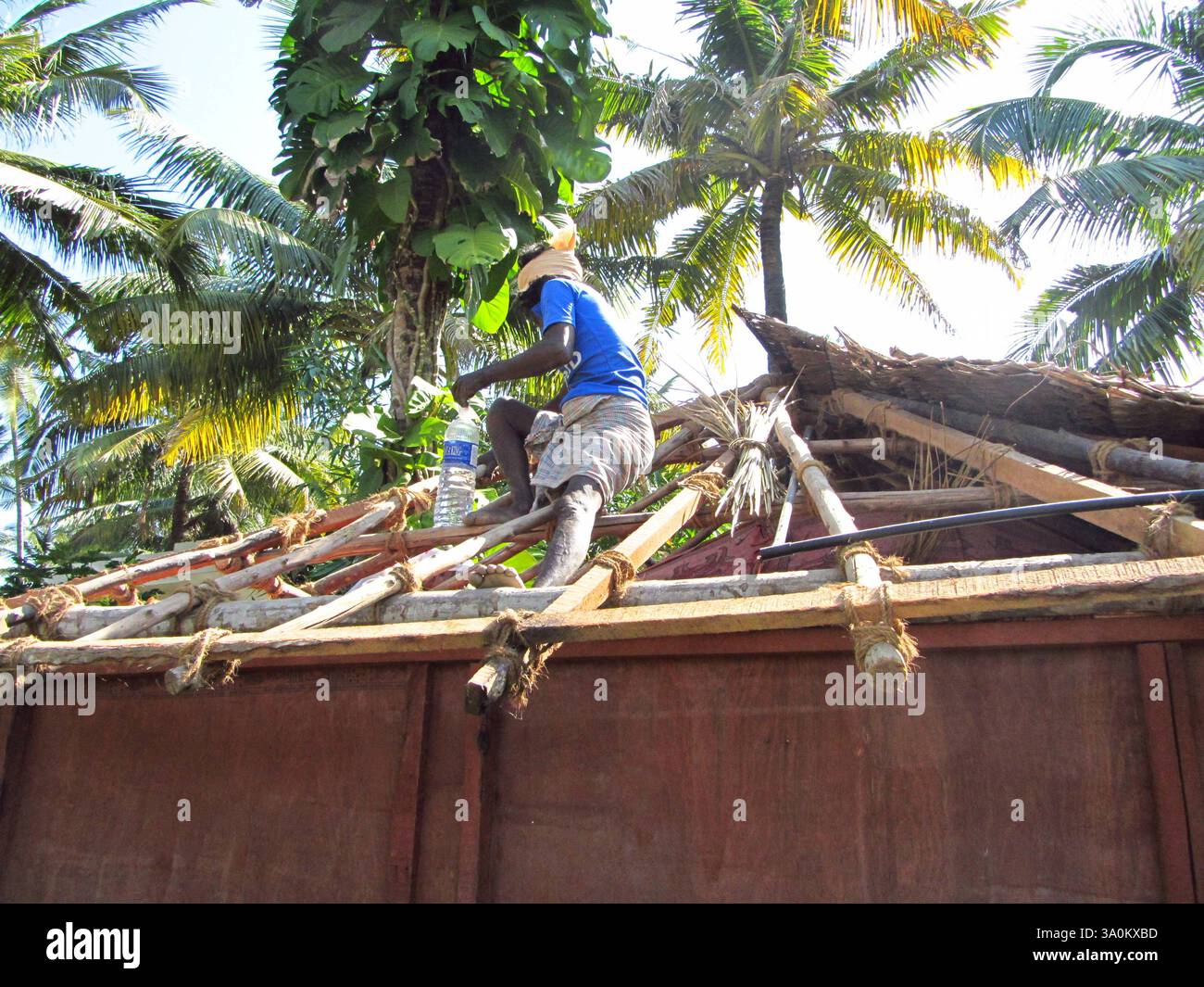 construction worker at topping out or roofing ceremony, when finishing ...