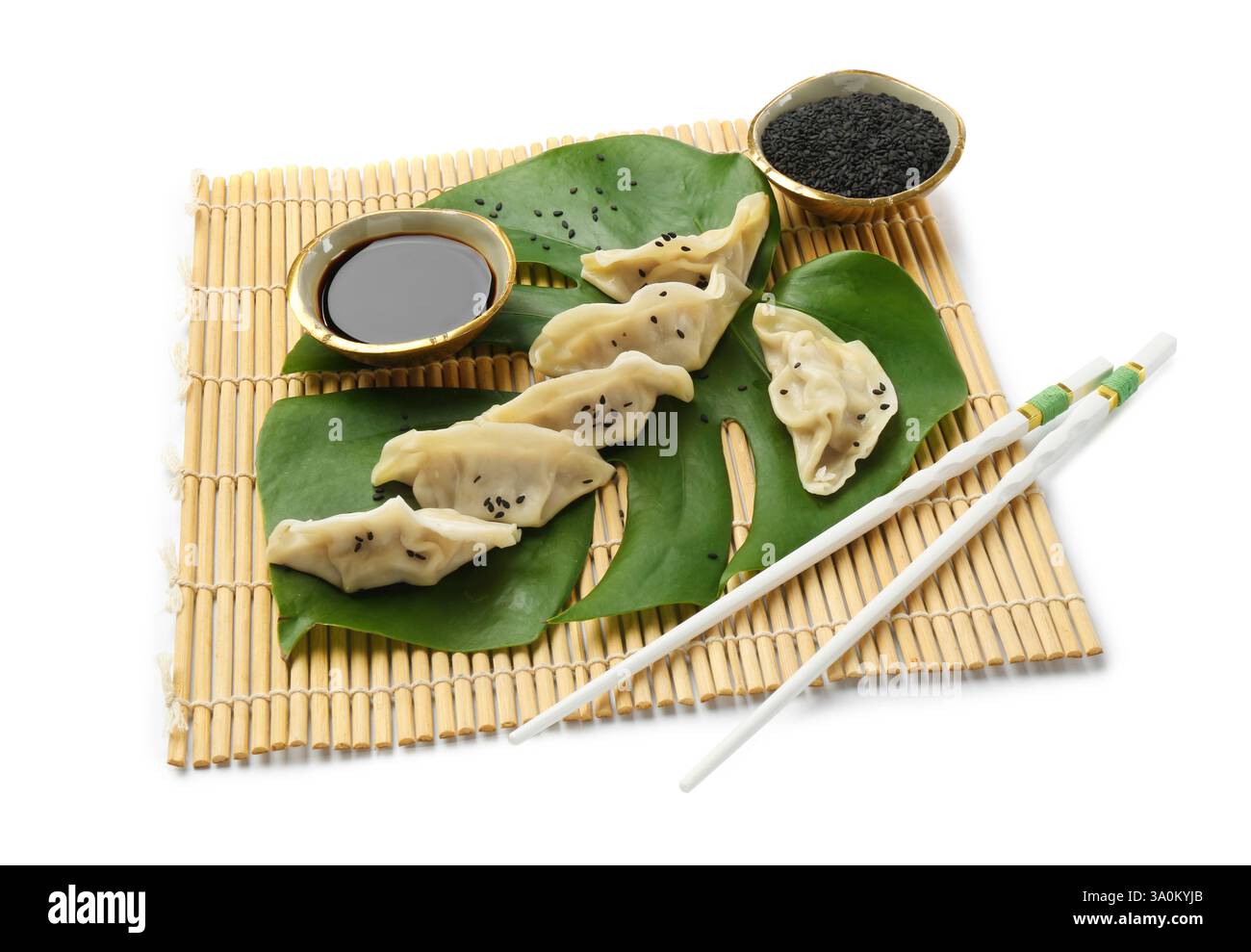 Tasty boiled gyoza (dumplings) with soy sauce, chopsticks and sesame on ...