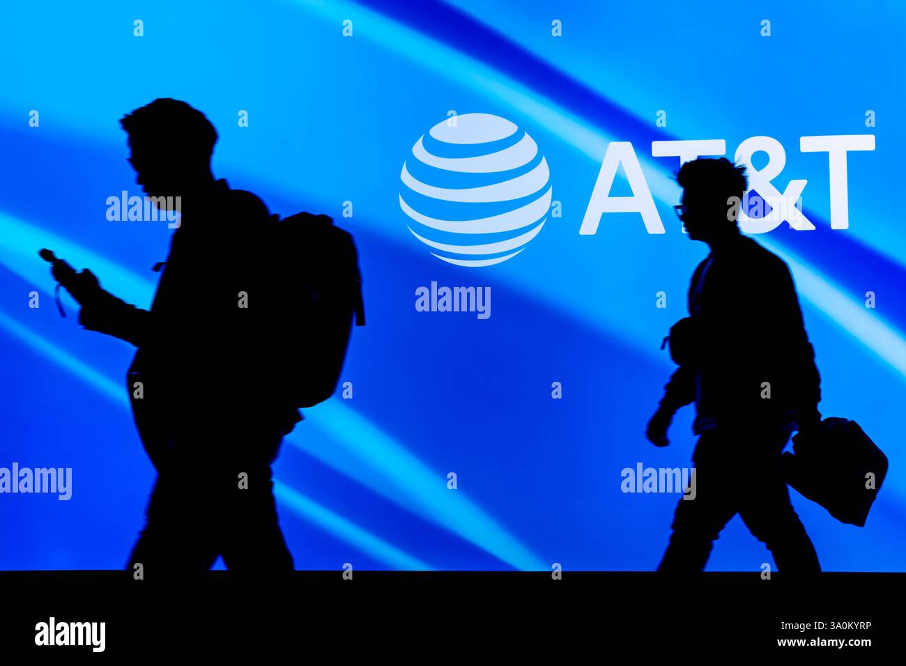 Barcelona, Spain. 4th Mar, 2025. A visitor walks past the At6T booth ...
