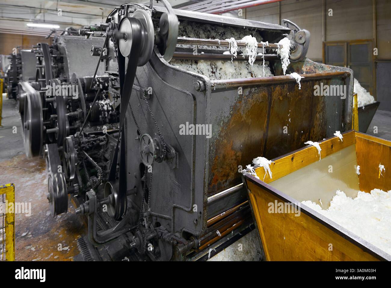Historic carding machine tirelessly processing raw fibers in a vintage ...