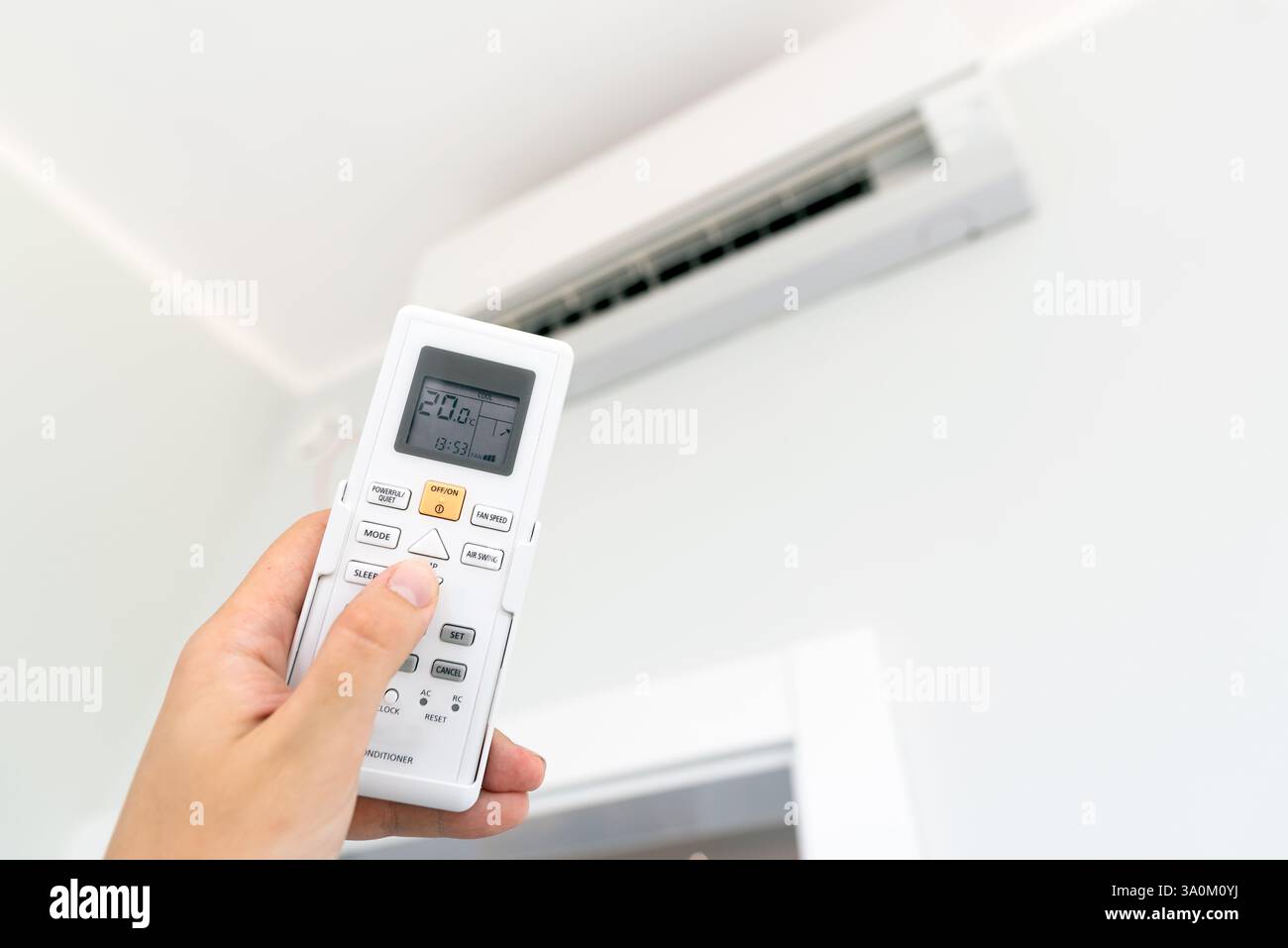 Air conditioner temperature adjustment with remote controller in room ...