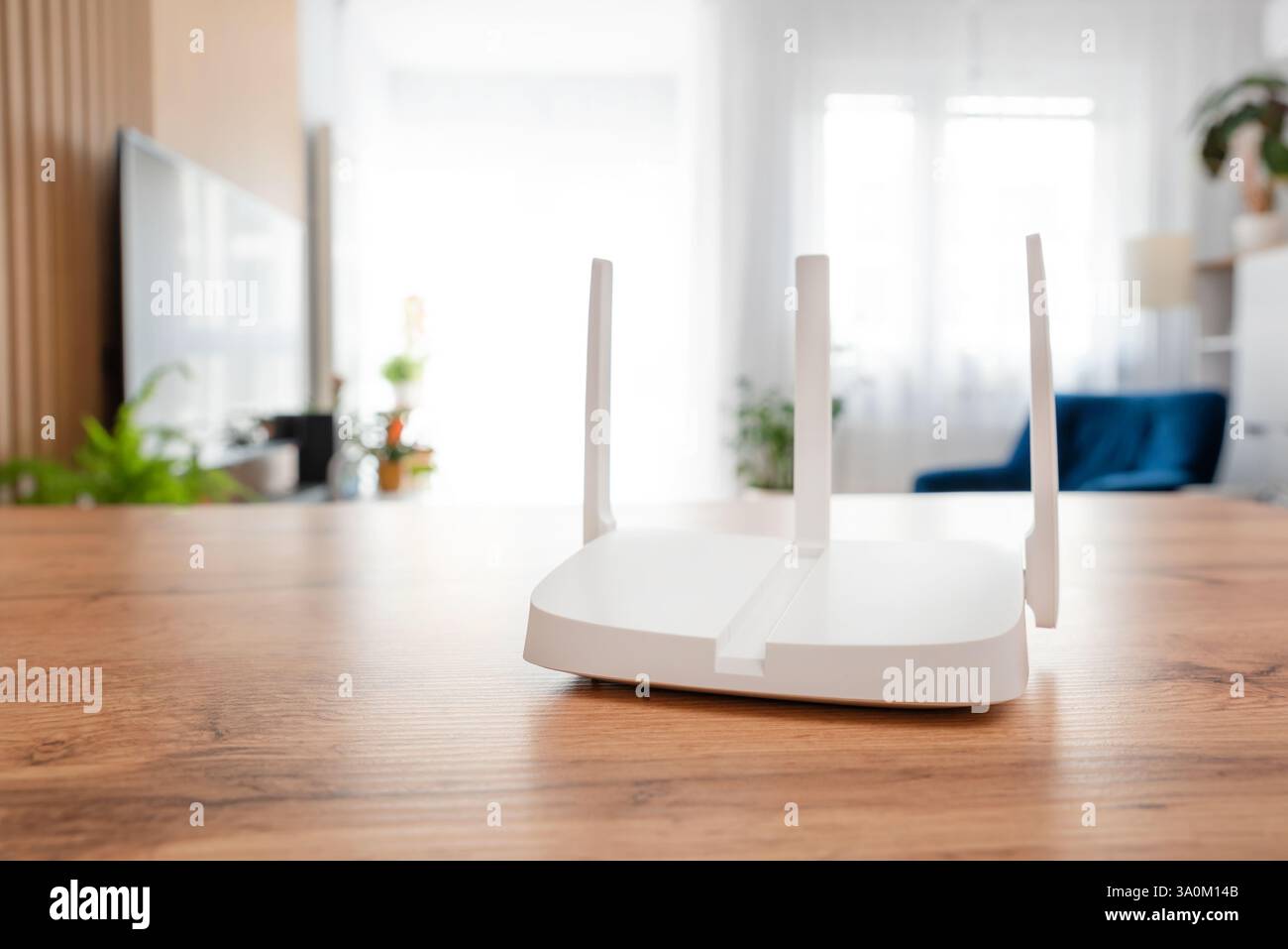 Modern wi-fi router on light table in living room Stock Photo - Alamy