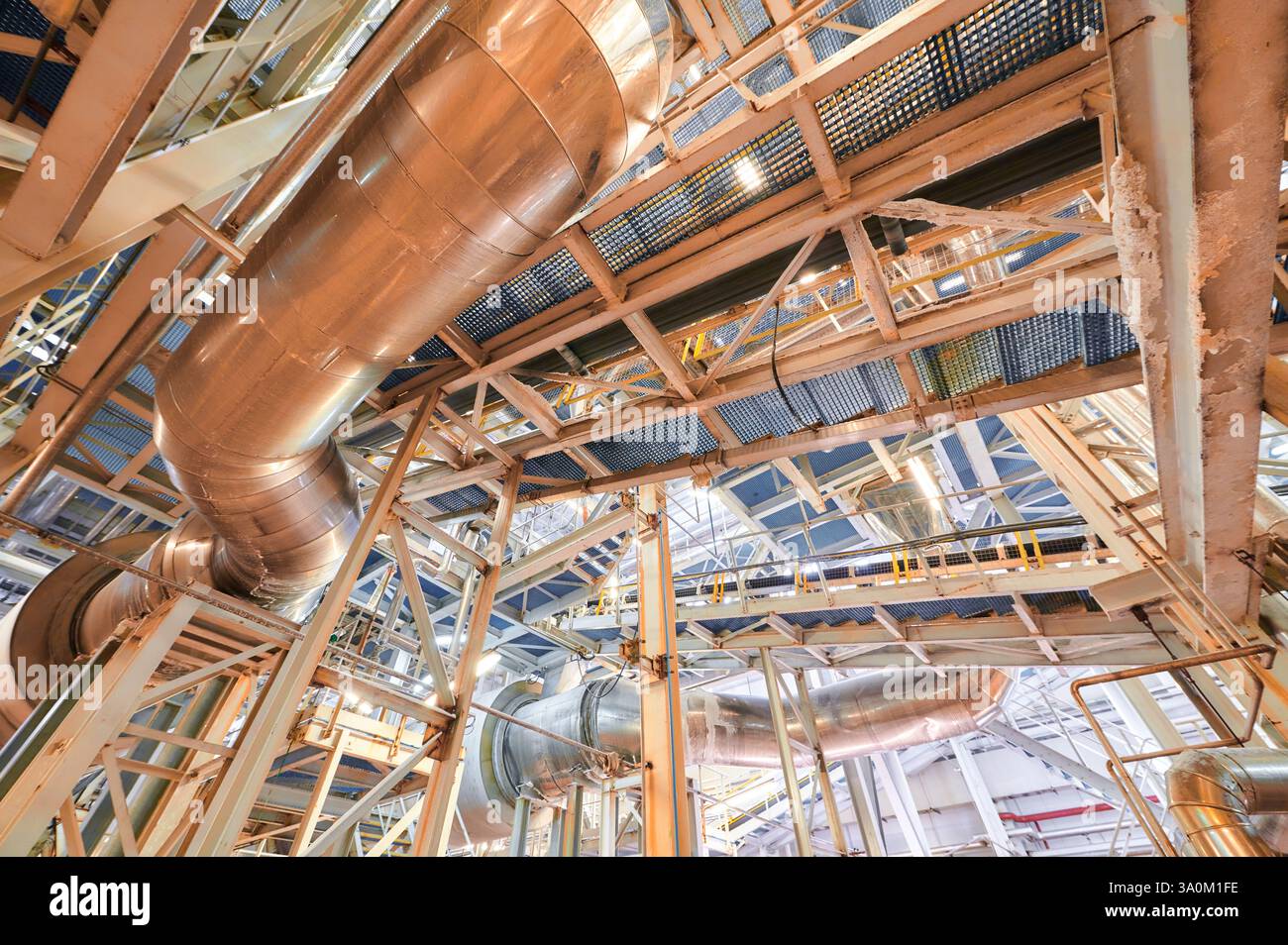 Modern chemical plant showcasing intricate pipelines and conveyor ...