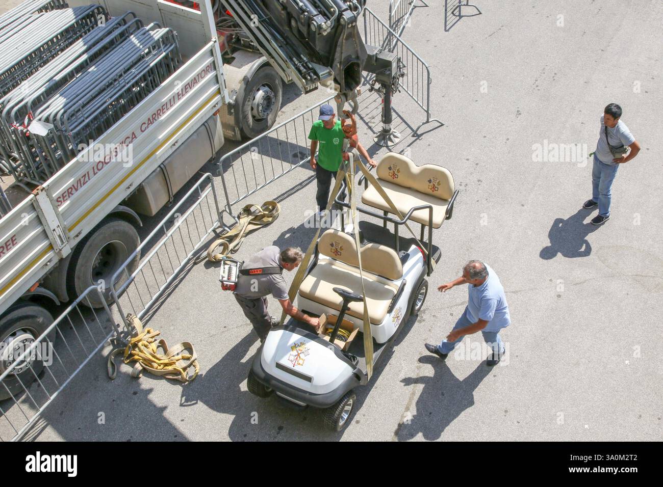 A specialty-adapted golf cart gets lifted the 2nd level of the Fiera di ...