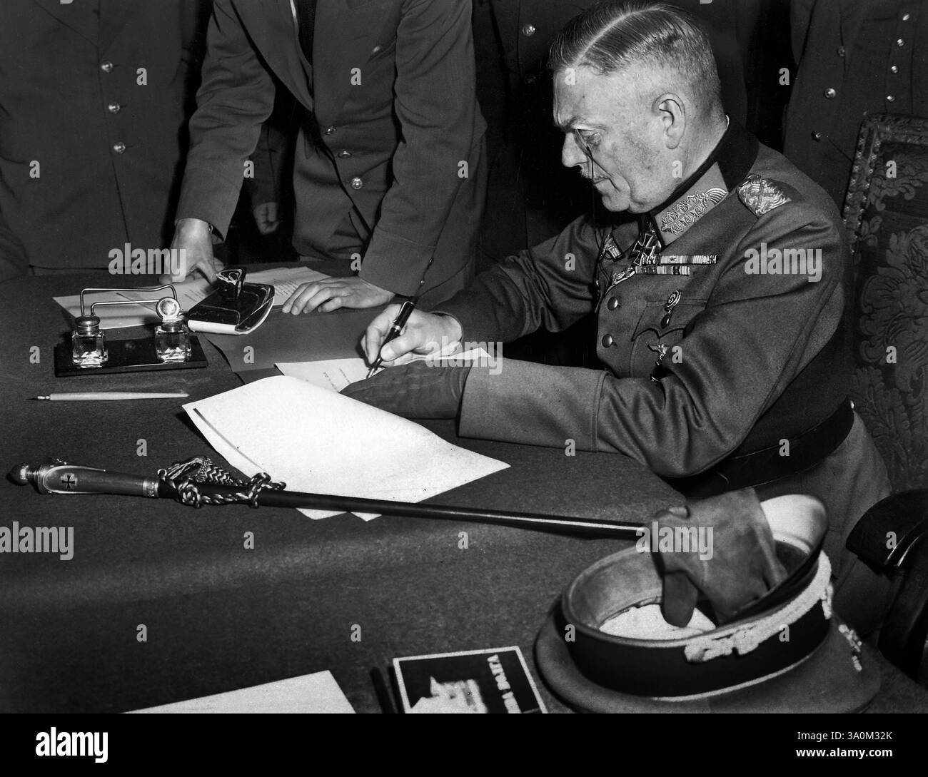 German Field Marshal Wilhelm Keitel, signing ratified surrender terms ...