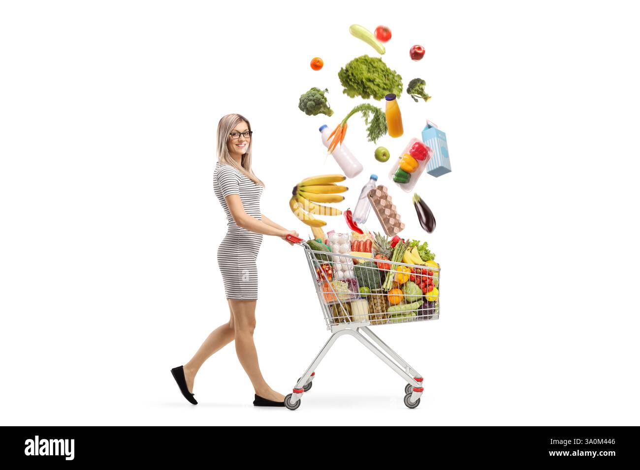 Woman and different food products falling into a shopping cart isolated ...