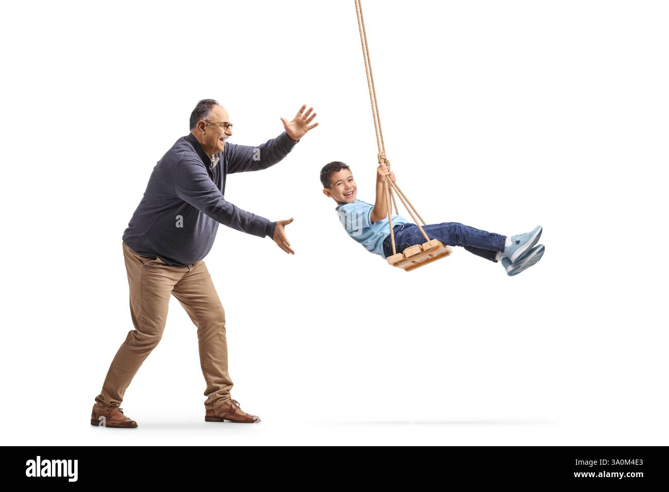 Full length shot of a grandfather pushing a kid on a swing isolated on ...