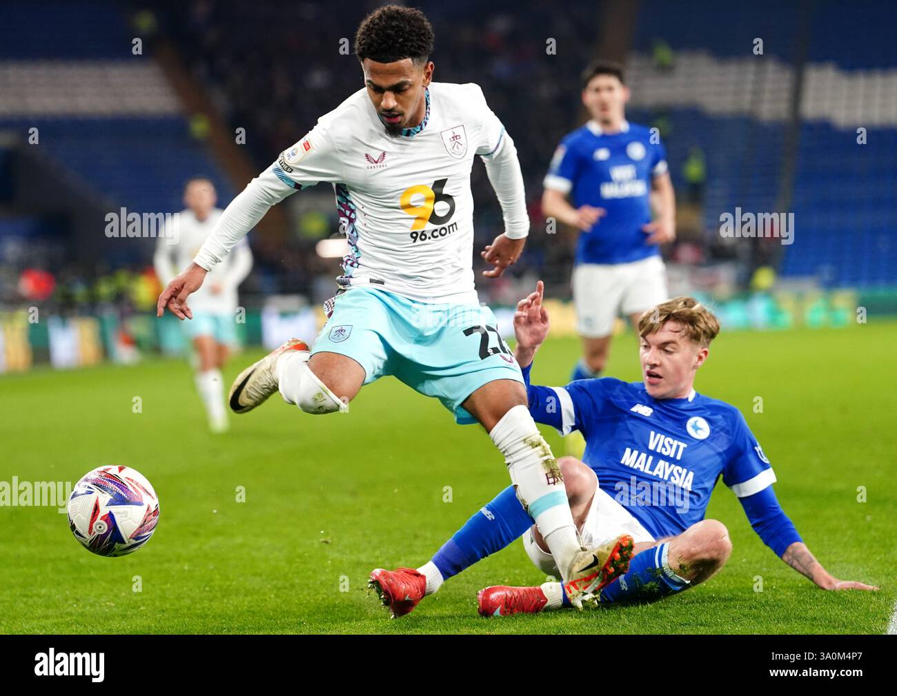 Burnley's Marcus Edwards and Cardiff City's Joel Bagan battle for the ...