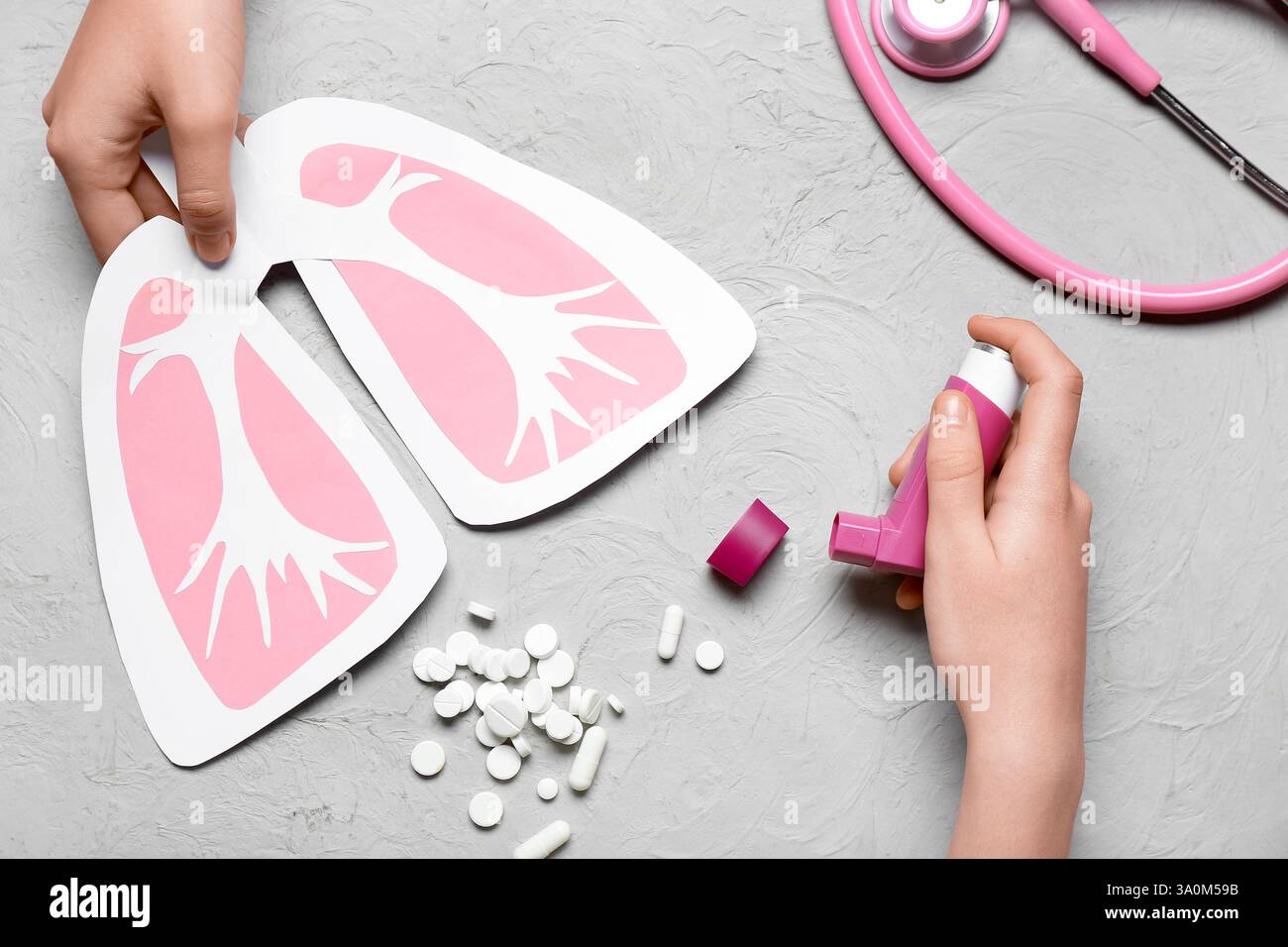Female hands with paper lungs, asthma inhaler, pills and stethoscope on ...