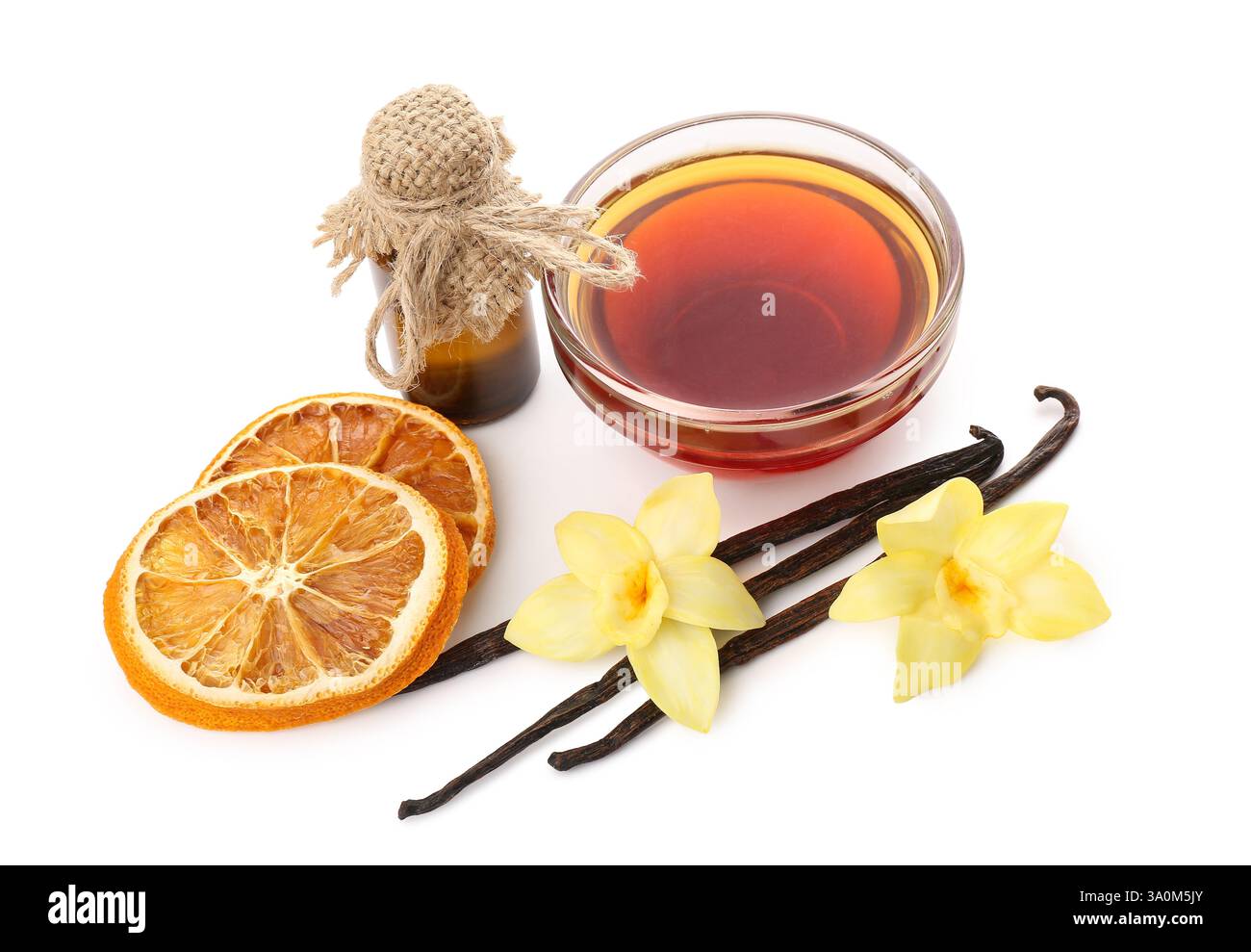 Composition with vanilla extract, sticks and flowers on white ...