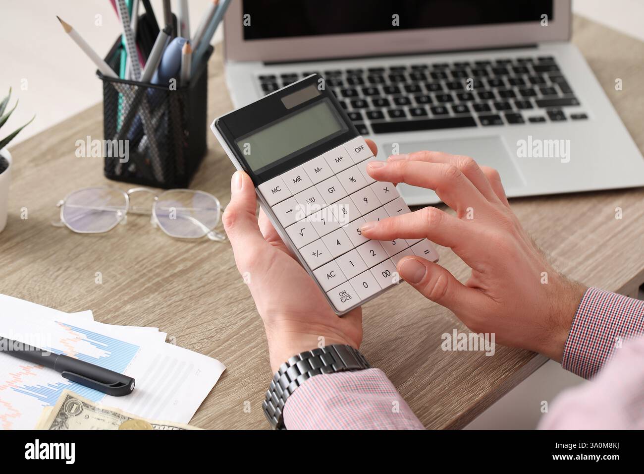 Office worker counting with calculator at table. Closeup Stock Photo ...