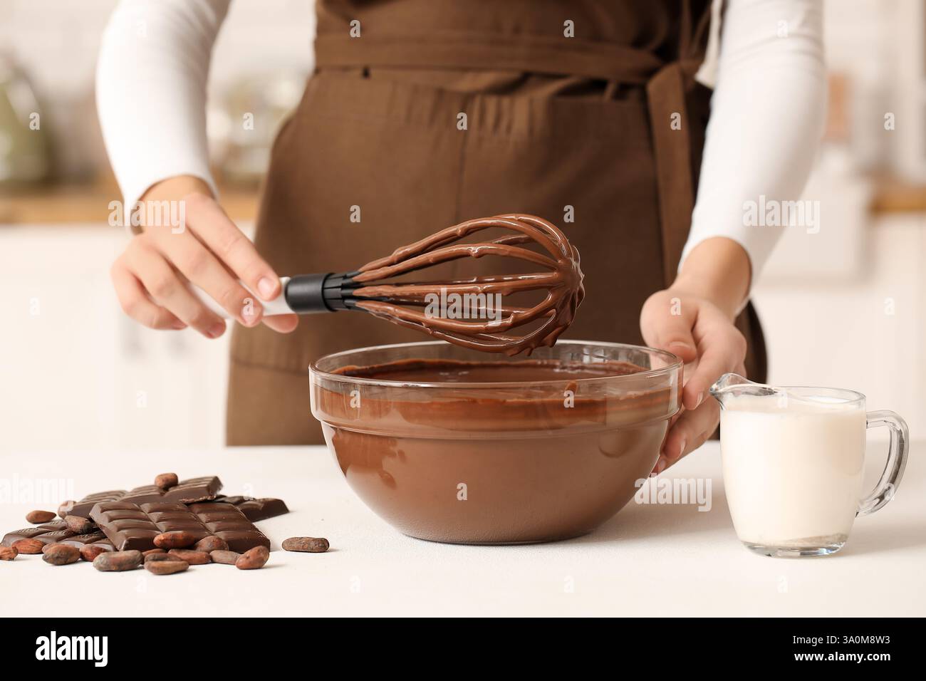 Woman whisking melted chocolate hi-res stock photography and images - Alamy