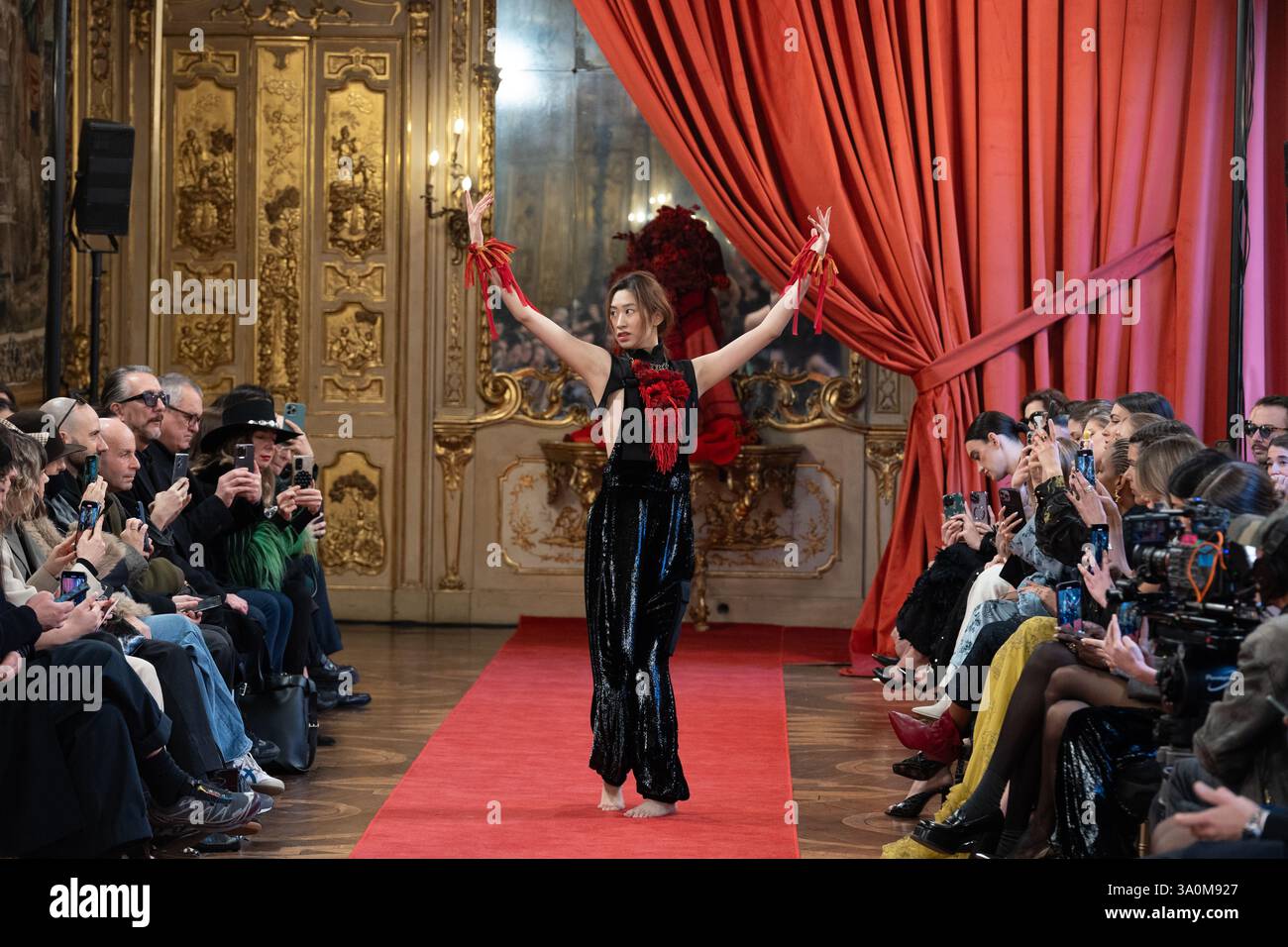 A dancer opens the HUI ''Aurora'' Fall/Winter 2025-2026 fashion show as ...
