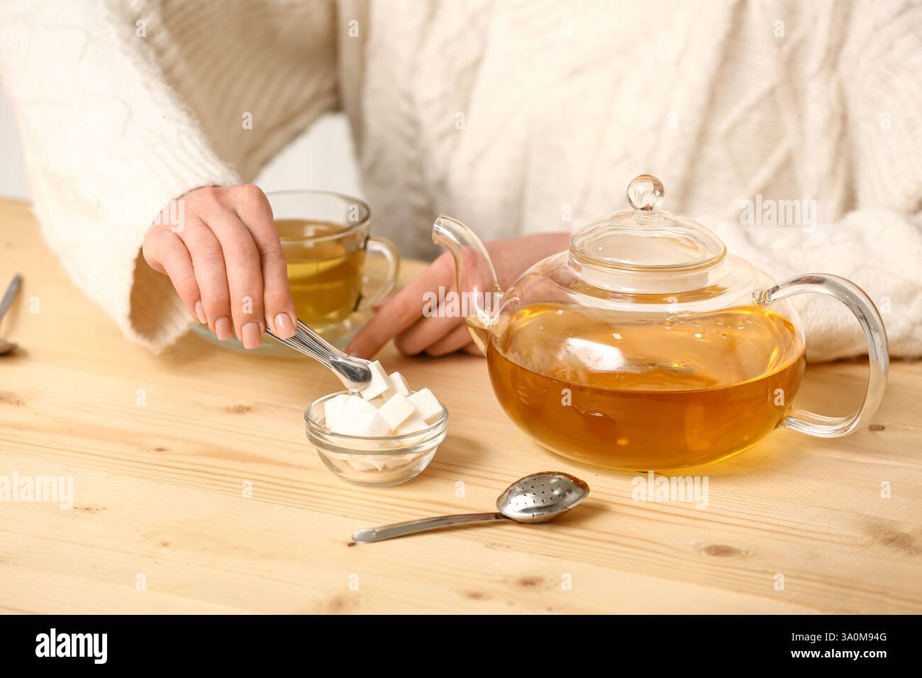 Woman taking lump of sugar at table in kitchen. Closeup Stock Photo - Alamy