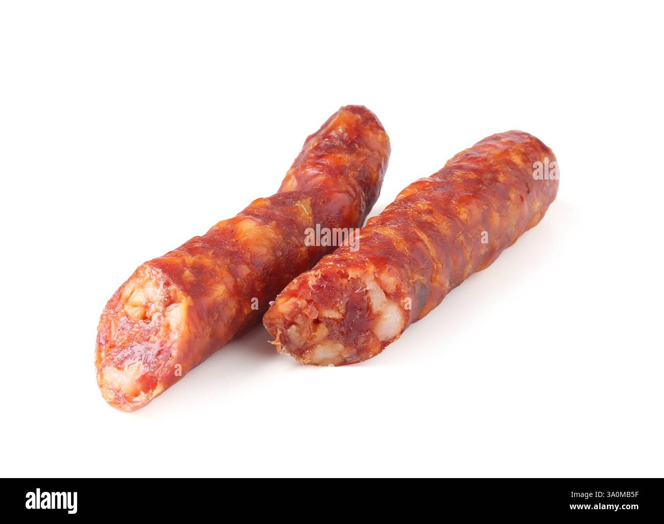 Pieces of delicious thin dry cured sausage isolated on white Stock ...