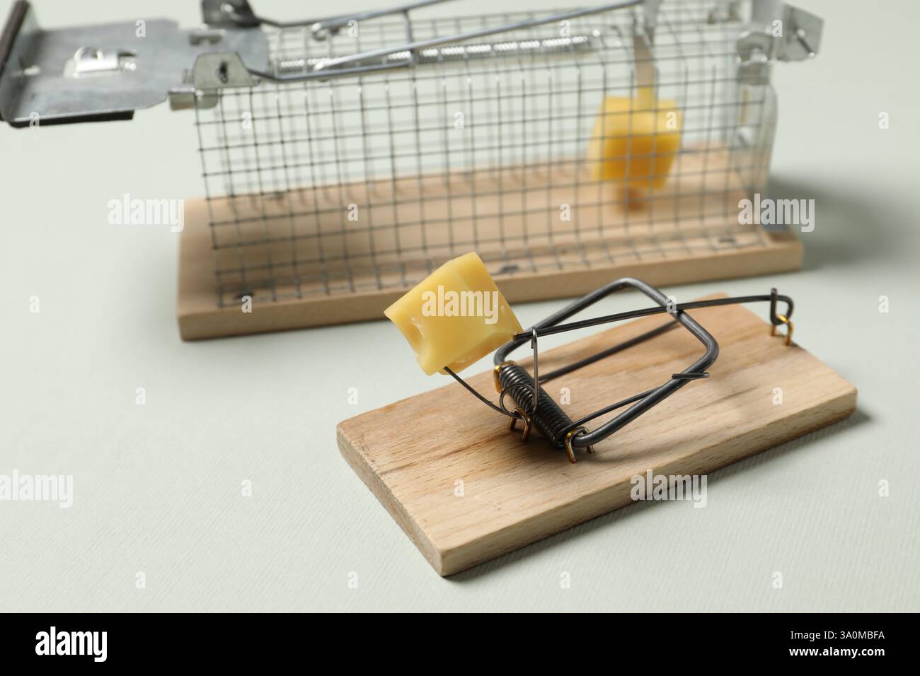 Two different mouse traps with bait on light background, closeup Stock ...