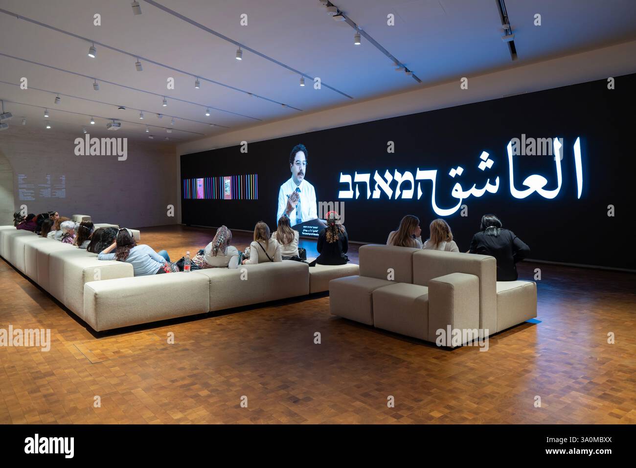 People sit and watch at an educational video at the new building of the ...