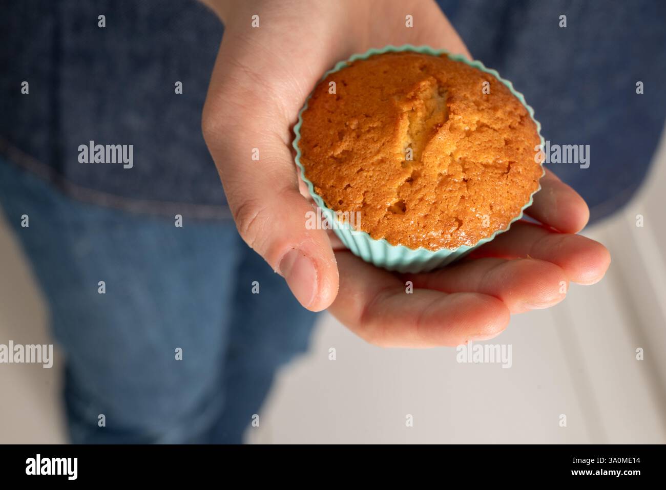 human hands holding home baked sweet lemon muffin Stock Photo - Alamy