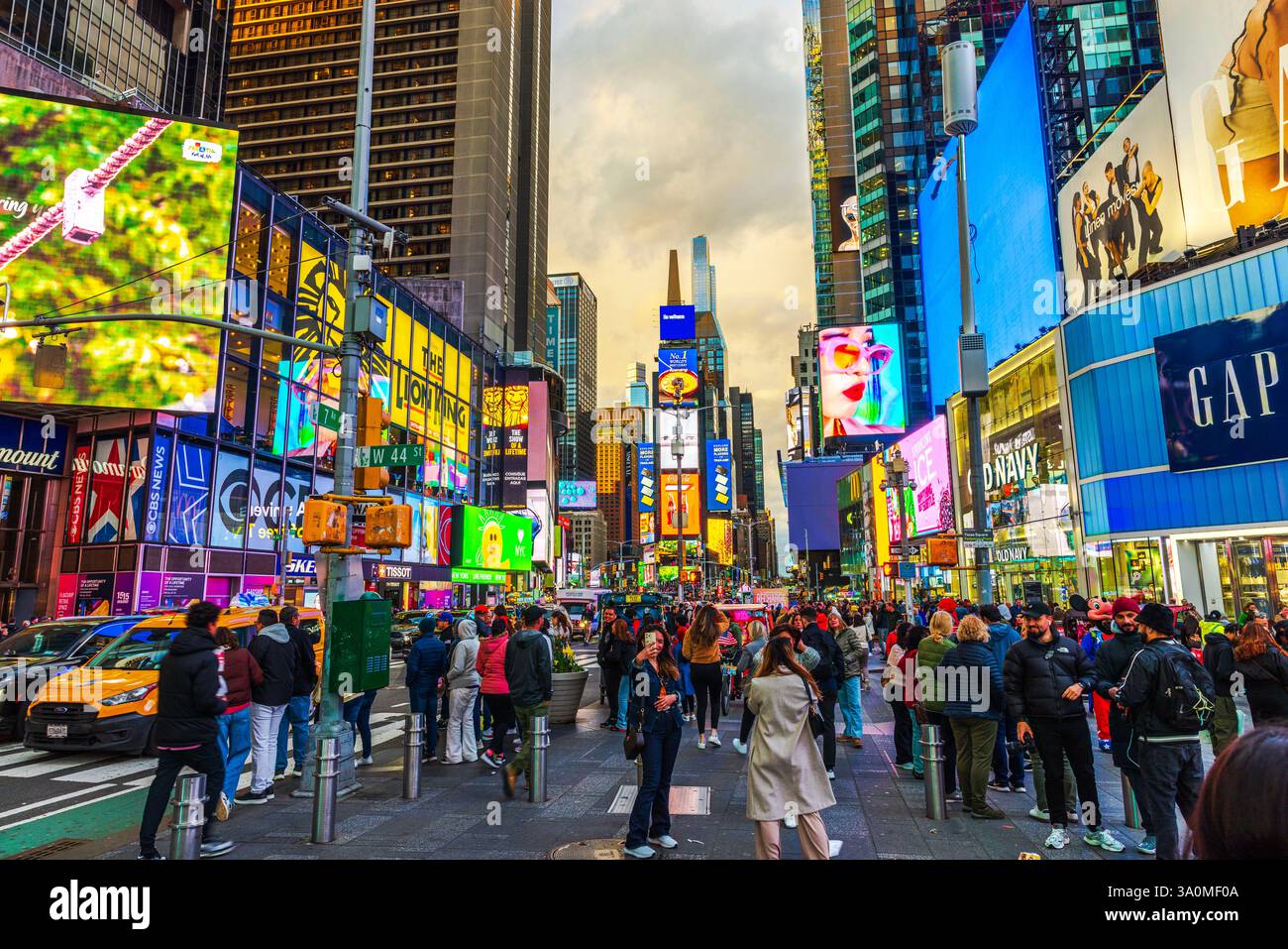 Times Square in New York City with bright billboards, including "The ...