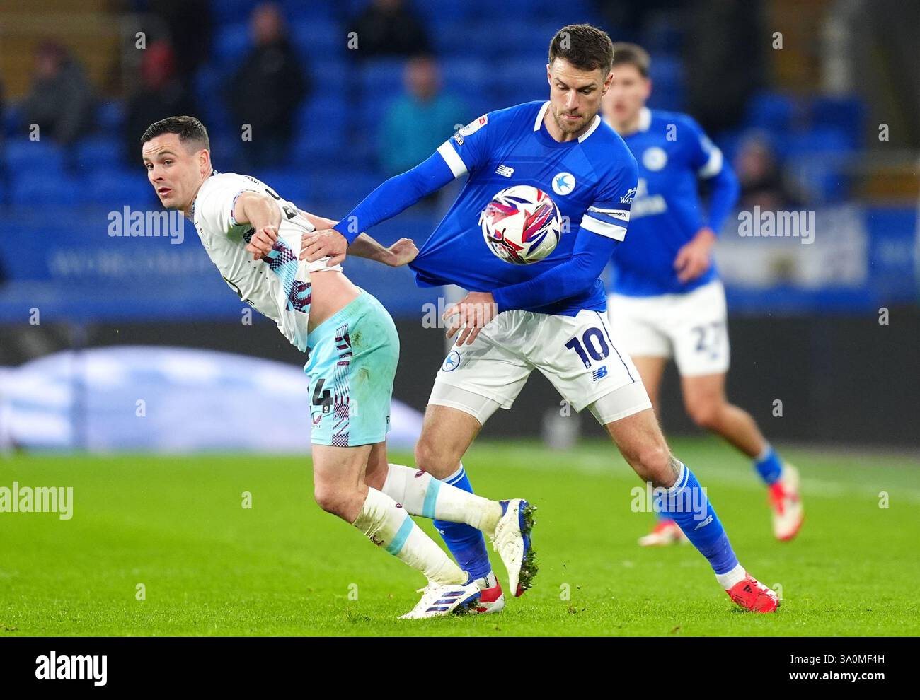 Burnley's Josh Cullen (left) and Cardiff City's Aaron Ramsey battle for ...