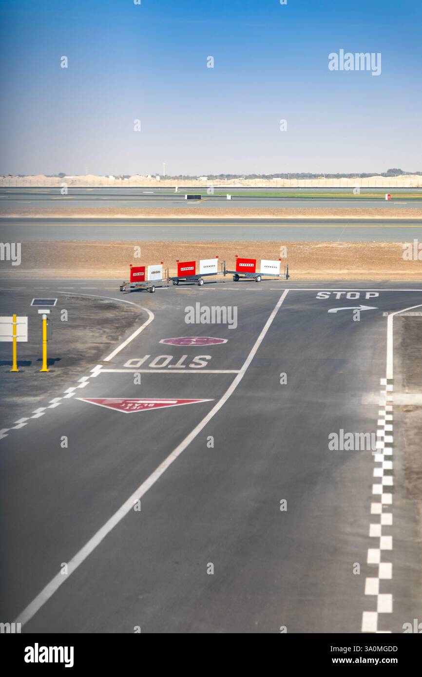 Abu Dhabi airport runway with clear markings and aircraft activity Stock Photo - Alamy