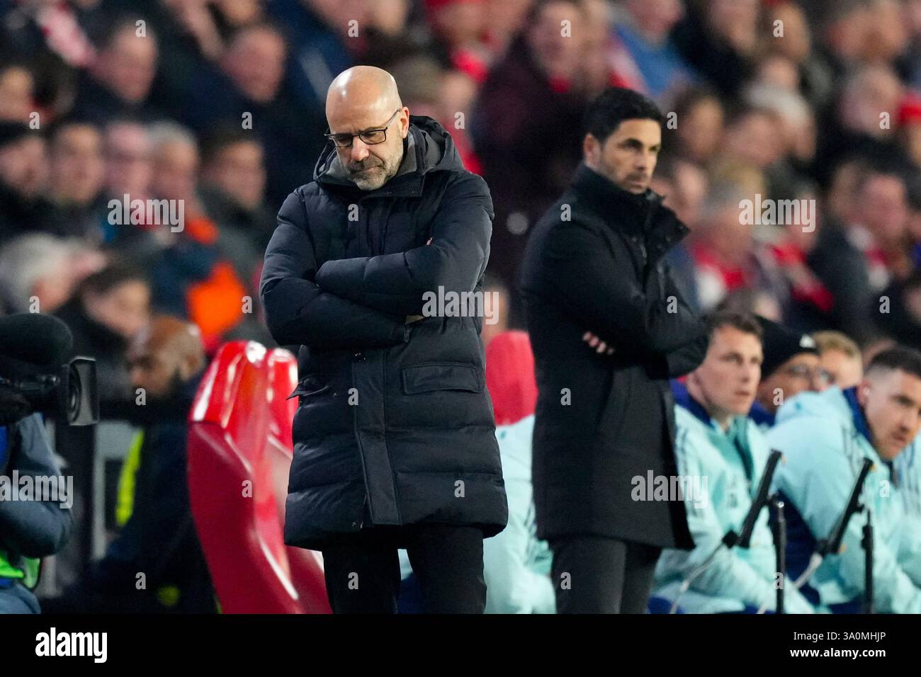PSV's head coach Peter Bosz, left, stands next to Arsenal's manager ...
