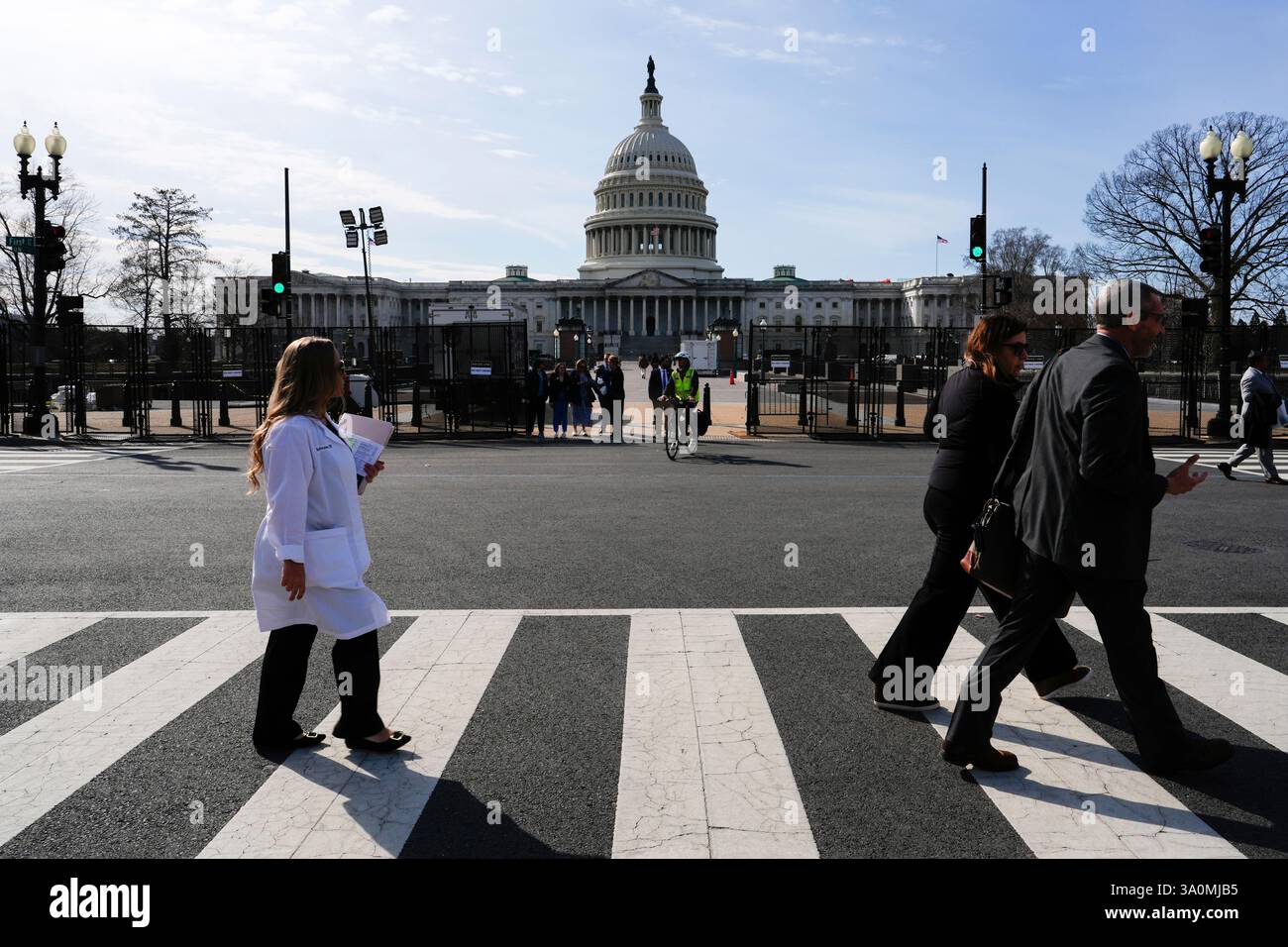 People walk in front of the Capitol, Tuesday, March 4, 2025, in ...