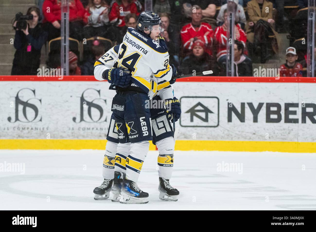 250304 HV71s Jonathan Ang och Oscar Fisker Molgaard jublar efter 1-3 målet under ishockeymatchen ...