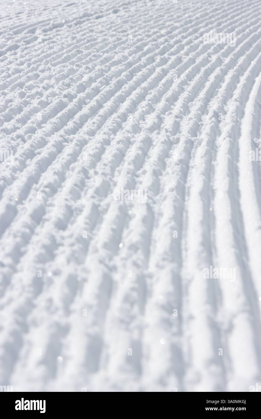 Curved lines in rough white snow surface texture abstract background ...