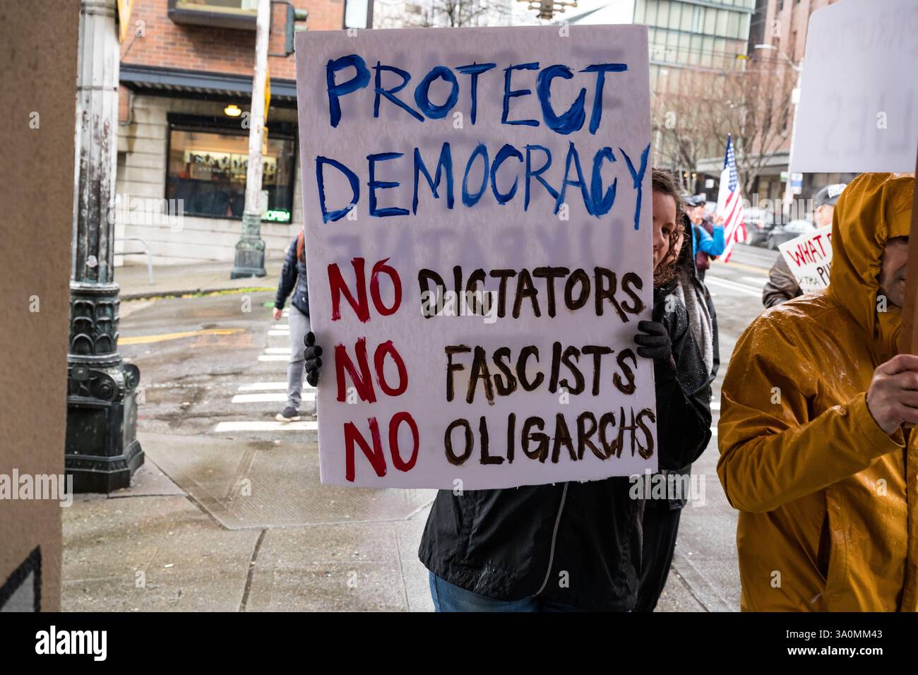 Seattle, USA. 4th Mar 2025. Activists march through Pike Place Market ...