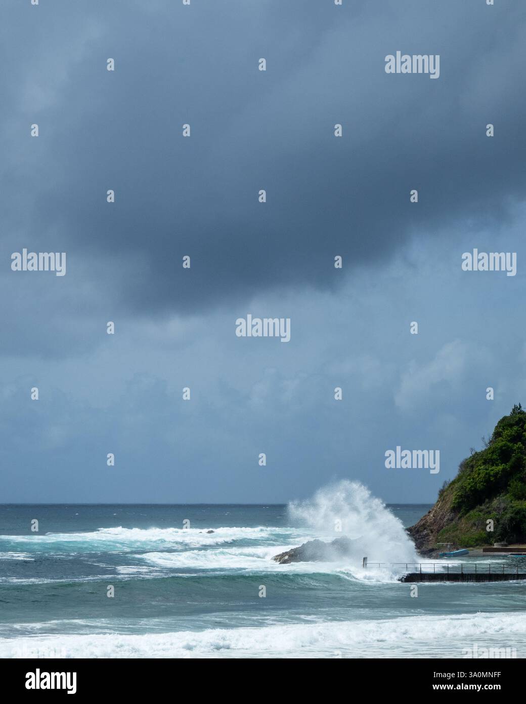 Waves crashing over the edge of the pool and splashing up into the air ...